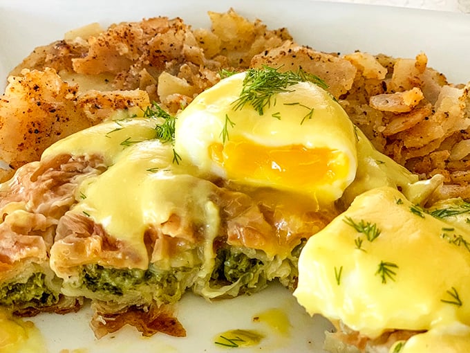 Eggs Benedict reimagined with salmon and spinach &ndash; proof that classics can evolve without losing their soul. Those home fries deserve their own zip code.