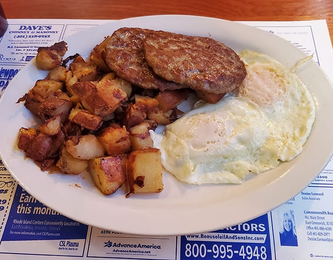 Breakfast perfection on a plate&mdash;crispy home fries, savory sausage patties, and eggs sunny-side up that practically high-five your taste buds.