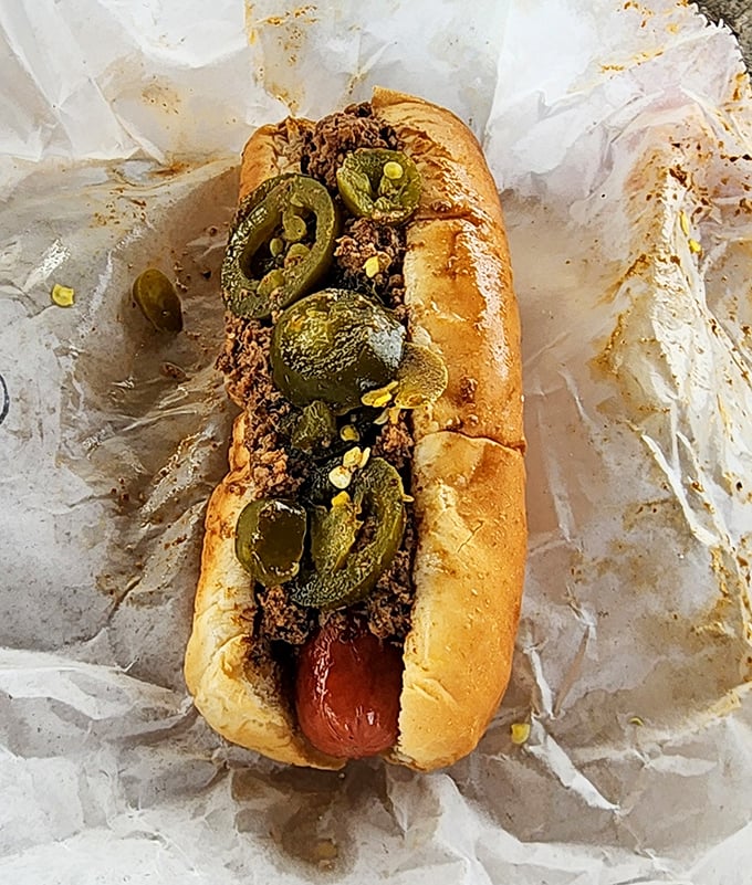 Chili, jalapeños, and a perfectly grilled hot dog—the holy trinity of comfort food that makes grown adults giddy with anticipation.