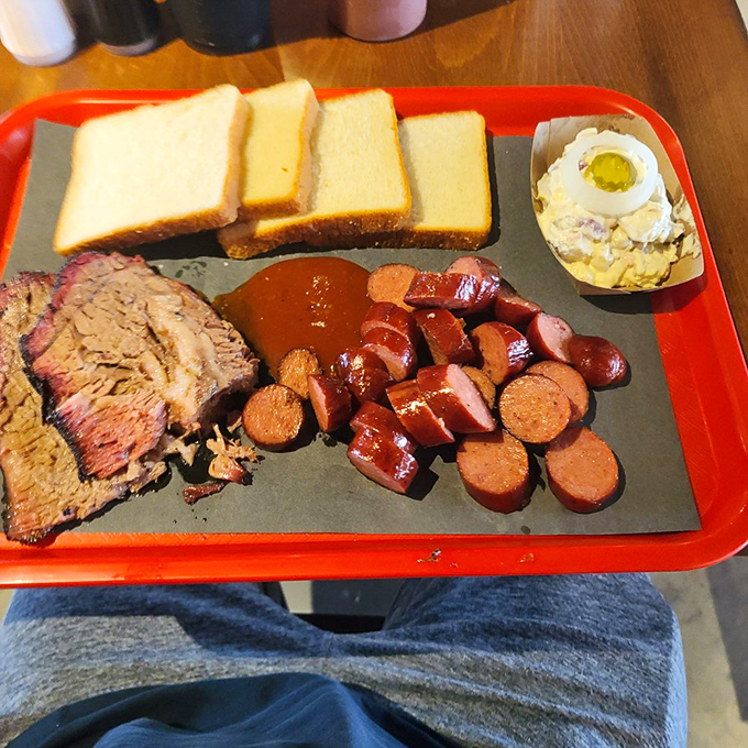 Barbecue's holy trinity: brisket, hot links, and white bread. Add potato salad and you've got a Texas communion that transcends mere hunger. 