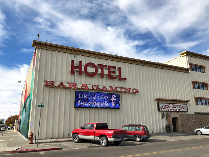 Nothing says "authentic Nevada" quite like a no-frills hotel advertising BAR & GAMING in bold letters. The pickup trucks parked outside complete the perfect Western tableau.