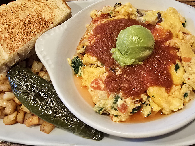 Huevos Rancheros that make you pause mid-bite to appreciate life's simple pleasures&mdash;perfectly scrambled eggs crowned with ranchero sauce and a dollop of avocado.