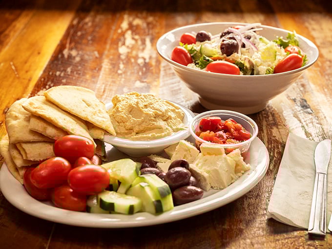 Mediterranean magic on a plate! This hummus platter isn't just a starter&mdash;it's a revelation with warm pita, fresh veggies, and creamy chickpea goodness.