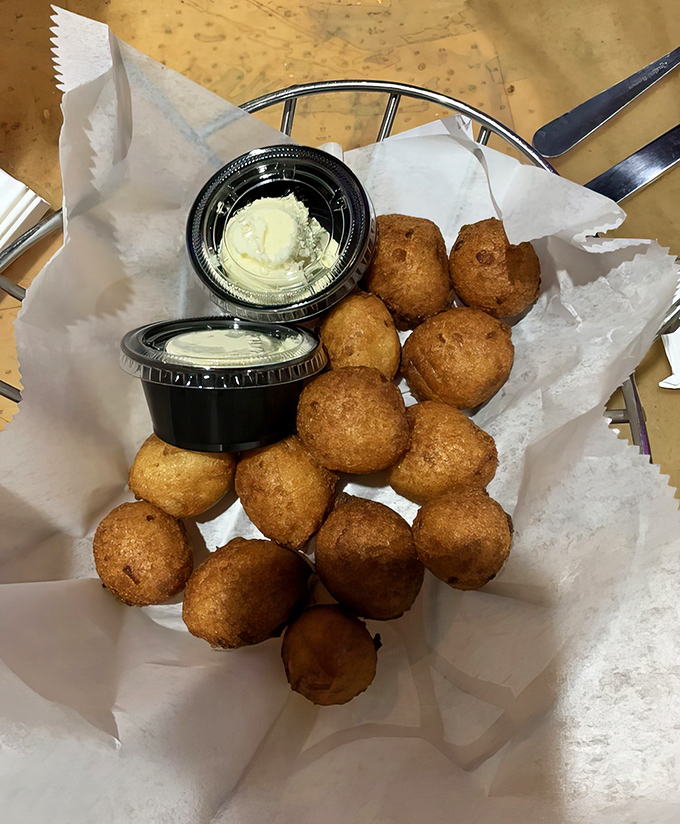 These golden-brown hush puppies aren't just side dishes; they're the opening act to a seafood symphony that's been playing to standing ovations for years.