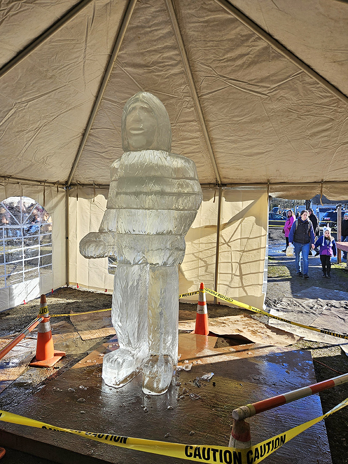 An ice sculpture stands guard in a tent, slowly surrendering to gravity and warmth. Ephemeral art that reminds us some treasures aren't meant to last forever.