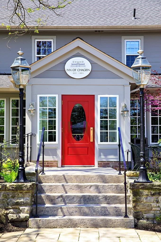 The Inn of Chagrin's red door says "come in" with the confidence of someone who knows they've mastered the art of hospitality and architectural charm.