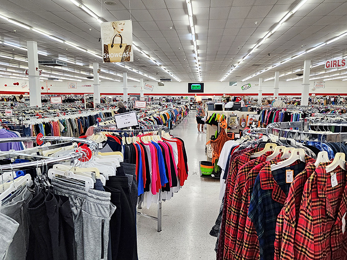 Rows upon rows of meticulously organized clothing stretch toward the horizon. This isn't just a thrift store; it's the Library of Congress for fashion recyclers. 
