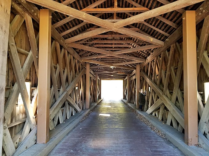 Inside Bulls Bridge, the lattice truss design reveals itself&mdash;a wooden cathedral of engineering genius that's both functional art and practical passage.
