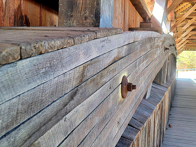 Weathered wood tells stories of countless crossings, with each beam and bolt working in harmony like an orchestra of engineering.
