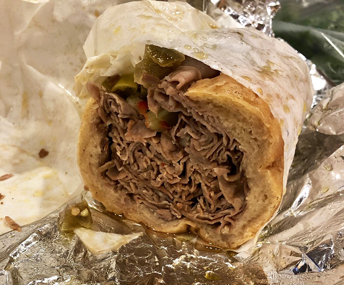 Behold the star of the show: thinly sliced beef, perfectly seasoned, piled high on bread that somehow stays intact despite the glorious juices. Italian beef nirvana.