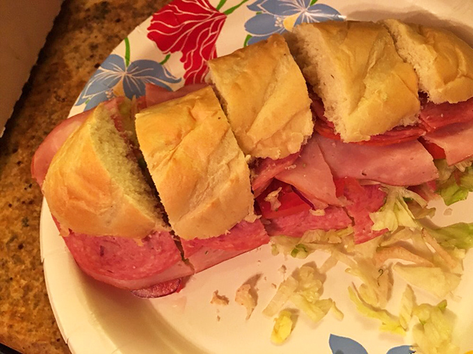 Behold the star attraction! This Italian sub isn't just a sandwich; it's an architectural marvel of perfectly balanced meats, cheese, and veggies on crusty bread.
