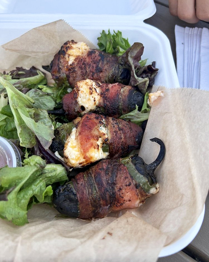 These aren't your average jalape&ntilde;o poppers&mdash;they're bacon-wrapped flavor bombs nestled on a bed of fresh greens.