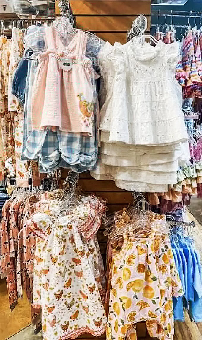 Tiny dresses with big personality hang in wait for the next generation&mdash;each stitch telling stories of tea parties and playground adventures yet to come.