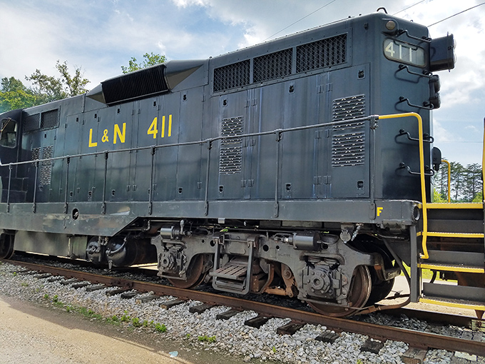 The L&N 411 diesel locomotive wears its blue-collar heritage proudly, a steel testament to the days when railroads were America's economic backbone.