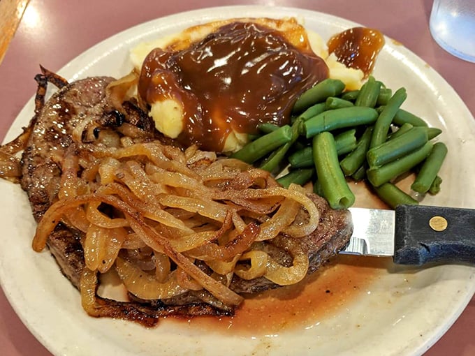 Behold the legendary liver and onions—tender, caramelized, and draped with onions so sweet they could make even vegetarians reconsider their life choices.