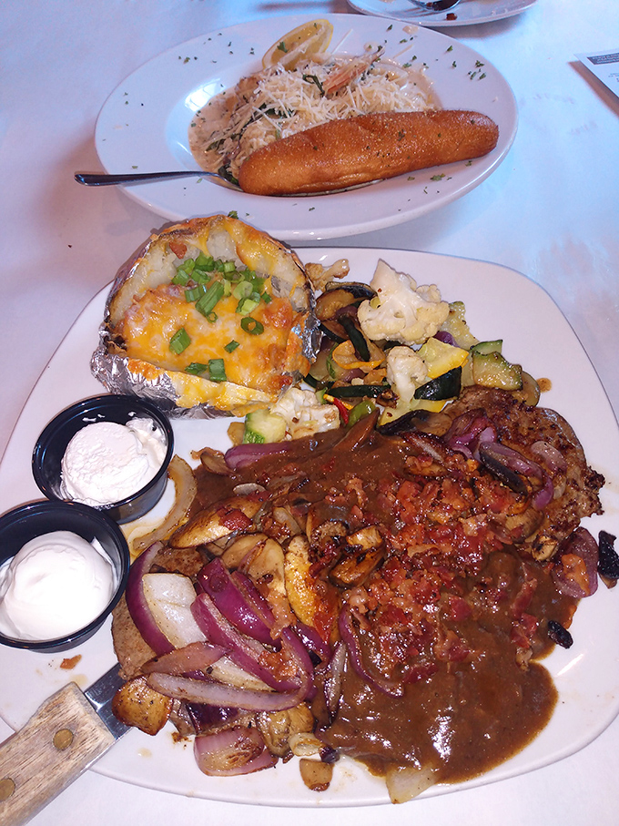 Liver and onions gets the royal treatment here, served alongside a loaded baked potato that's practically begging to be devoured.