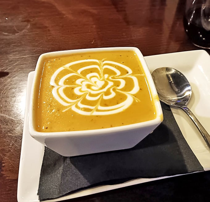 The lobster bisque arrives like a work of art, with that cream swirl pattern that says, "Yes, we're serious about our soup game here."