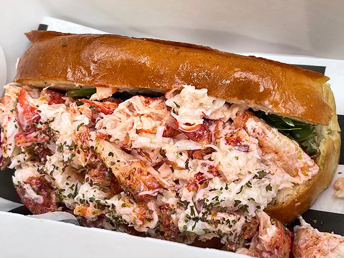 Behold the star attraction: chunks of sweet lobster meat nestled in a perfectly toasted roll. This isn't just lunch; it's a religious experience.