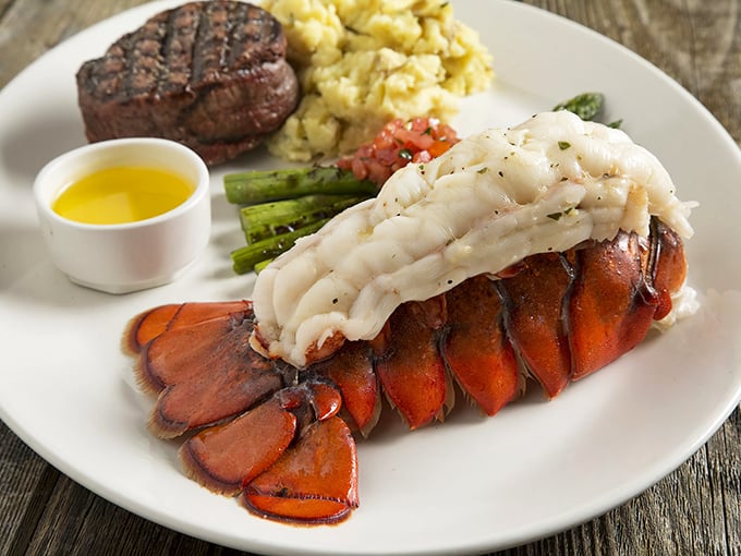 Behold the star attraction! This lobster tail isn't just seafood; it's a butter-bathed celebration that makes even the most dignified diners close their eyes in bliss.