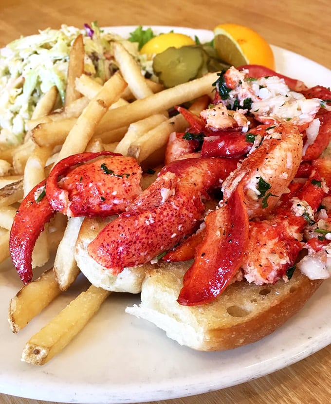 The legendary lobster roll in all its glory! Chunks of sweet meat spilling over the edges like they're making a break for freedom.