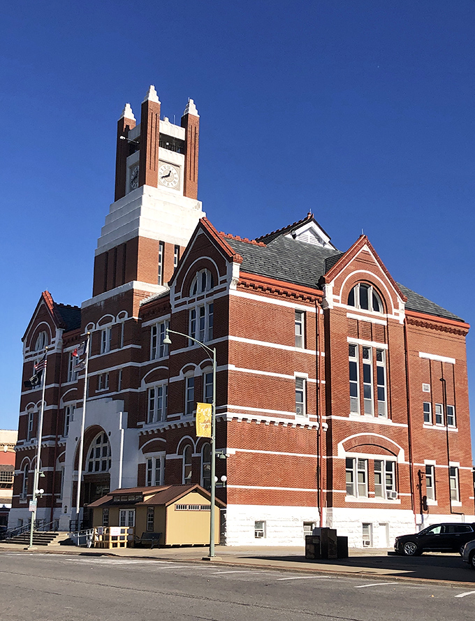 The Mahaska County Courthouse stands as a red-brick testament to when public buildings were built to inspire, not just house bureaucratic paperwork.