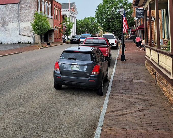 Brick sidewalks and American flags frame Main Street's parade of storefronts. This isn't a theme park—it's a living, breathing town that happens to be gorgeous.