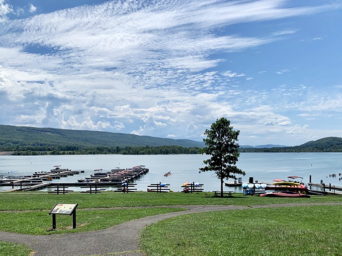 Boat docks stretch toward the horizon like wooden fingers reaching for the mountains. Kayaks wait patiently for their next aquatic adventure.