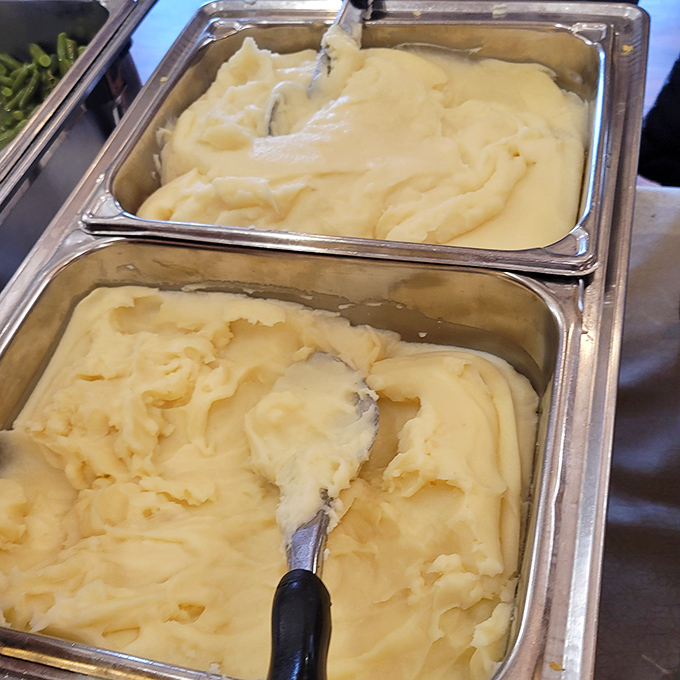 Behold the buffet's mashed potato station, where creamy dreams are served and second helpings are basically mandatory by unwritten law.