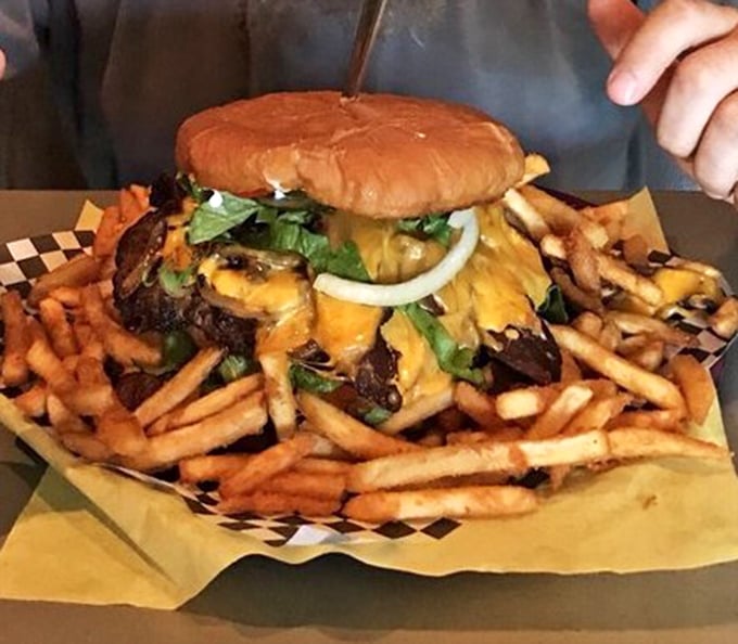 This isn't just a burger with fries&mdash;it's a skyscraper of beef and cheese with a french fry foundation. Structural engineering at its tastiest.