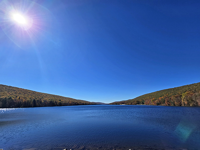 Mirror-like waters reflect the Pocono Mountains at Mauch Chunk Lake Park, offering a moment of serenity that feels like Mother Nature's own meditation app.