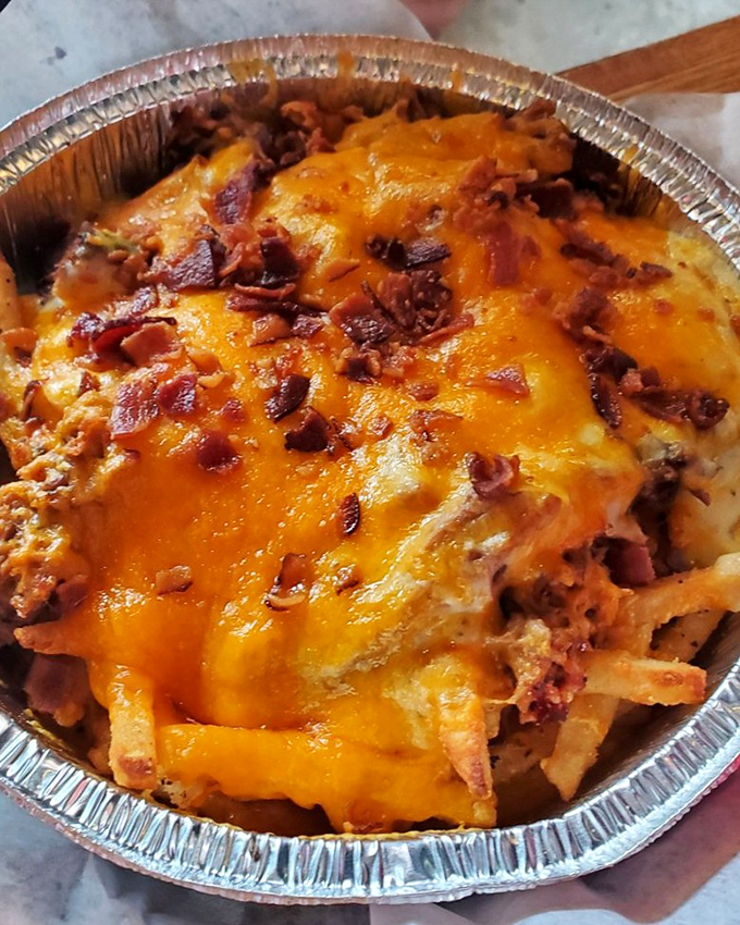 The legendary Meat Fries in all their glory. Crispy fries buried under a mountain of house gravy, melted cheddar, pulled pork, brisket, and bacon&mdash;a beautiful mess worth every napkin.