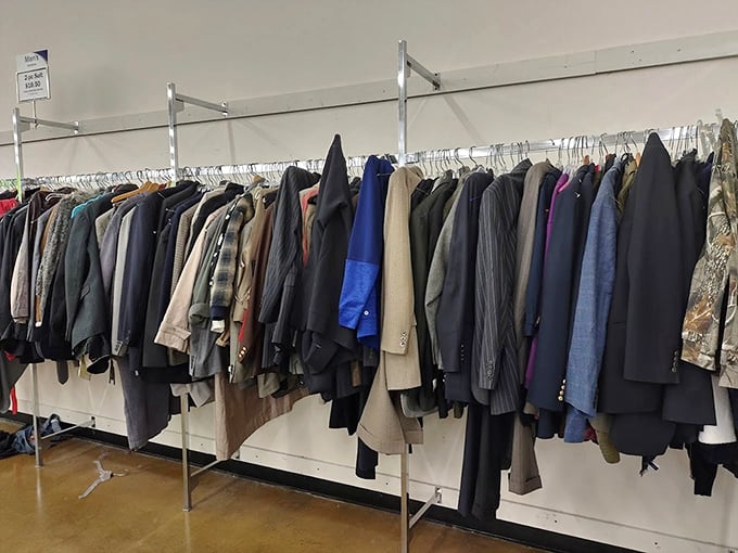 Men's suits and jackets hang with dignity, patiently waiting for their next interview, wedding, or chance to make someone look like a million bucks for twenty.
