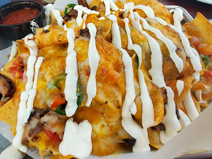 These nachos arrive looking like Mount Delicious erupted all over your plate, with brisket that practically melts on contact.