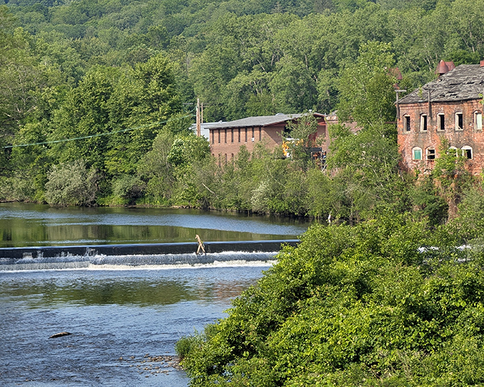 The Naugatuck River doesn't just flow through Thomaston &ndash; it shaped it, both literally and economically, creating this postcard-worthy scene that no filter could improve.