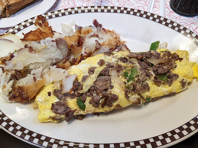 This isn't just an omelet&mdash;it's a masterpiece of morning architecture with perfectly crisped home fries that deserve their own fan club.