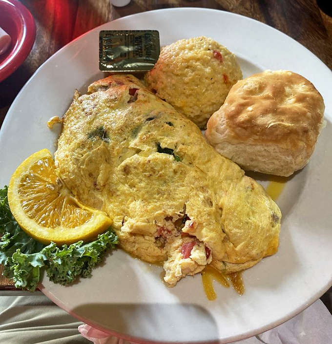 Behold the golden perfection: a fluffy omelet with sides that understand the true meaning of Southern hospitality on a plate.