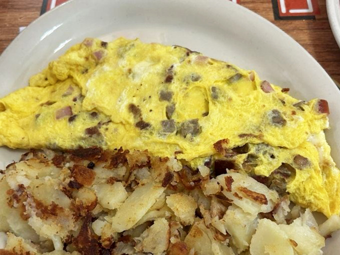 Behold the star attraction: a perfectly executed omelet that manages to be both substantial and cloud-like, with home fries that demand equal attention.