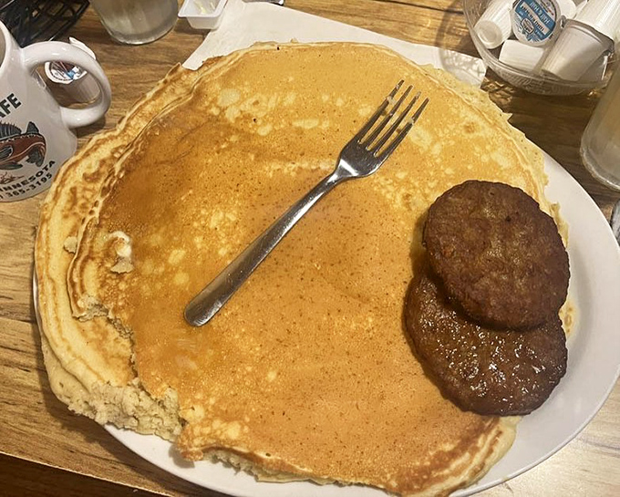This pancake is so enormous it needs its own zip code. The sausage patties stand guard, but they're no match for your appetite.