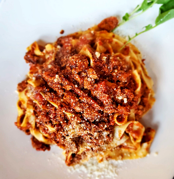 The legendary Pappardelle Bolognese in all its glory. Wide ribbons of pasta embraced by a sauce that's been simmering since before you made reservations.