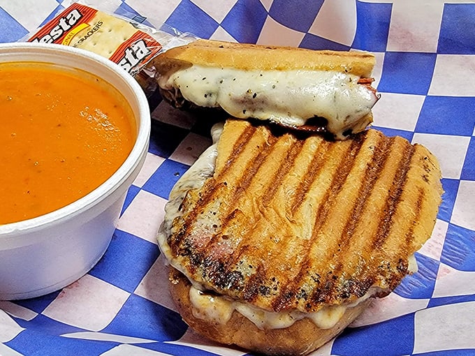 This grilled sandwich and tomato soup combo isn't just lunch&mdash;it's therapy on a blue-checkered paper, complete with that perfect cheese pull.