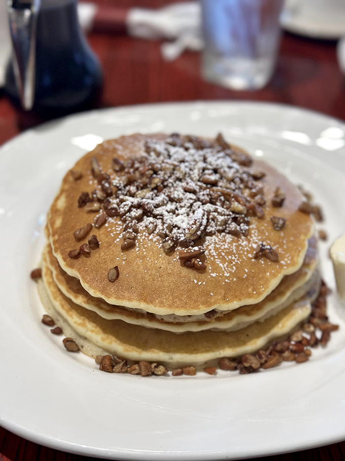 Pecan pancakes that deserve their own zip code&mdash;crunchy nuts, fluffy centers, and a dusting of powdered sugar perfection.