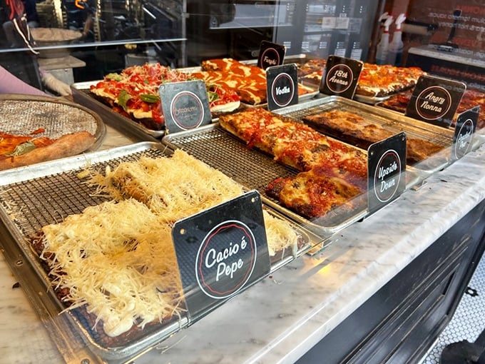 Pizza display case or art gallery? At Mama's TOO!, the line blurs. Each labeled creation waits patiently for its moment of glory on your plate.