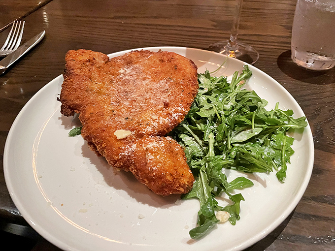 The Veal Chop Milanese: where crispy exterior meets tender meat in a relationship more perfect than any Hollywood romance.