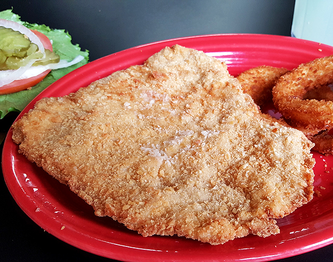 Behold the pork tenderloin in all its golden, plate-conquering glory—this is why Indiana takes its breading seriously.