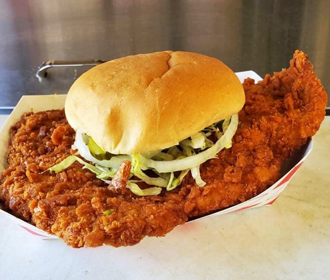 Behold the sandwich that ate Kansas City! This golden-brown masterpiece of pork tenderloin requires both hands, napkins aplenty, and absolutely zero dignity while eating.
