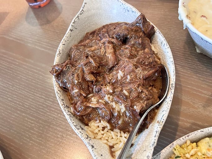 Pot roast so tender it practically surrenders at the sight of your fork, nestled on a bed of rice ready to soak up that glorious gravy.