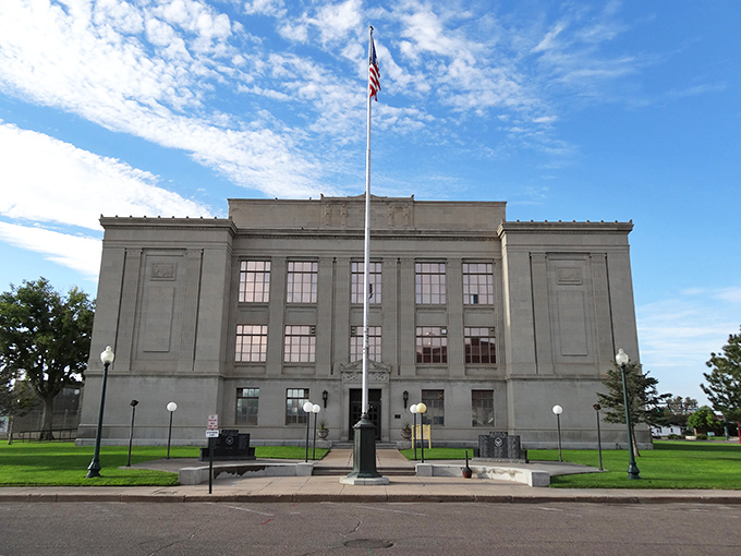 Prowers County District Court building stands sentinel-like against the sky, its classical lines and symmetry a testament to an era when civic architecture inspired awe.