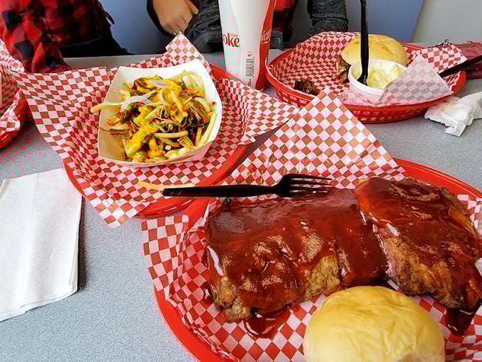 Behold the star attraction: pulled pork glistening with sauce alongside golden fries – a carnivore's dream come true.