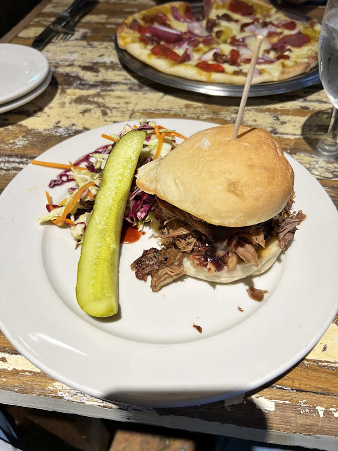 The legendary pulled pork sandwich arrives like a humble hero&mdash;no cape, just a pickle spear sidekick and slaw that adds the perfect crunch to each heavenly bite.