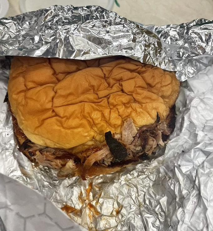 The legendary pulled pork sandwich arrives like a meat-lover's dream, tender and smoky with that perfect bark. This isn't just food&mdash;it's edible architecture.